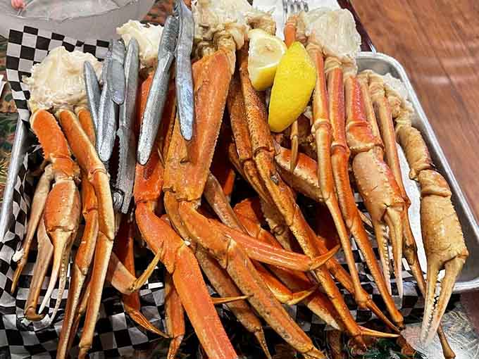 Snow crab legs piled high with lemon wedges, ready to make your hands messy and your heart happy.