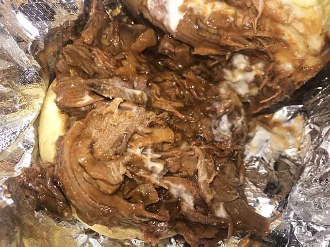 Pulled pork so tender it surrenders without a fight, glistening with sauce and pure barbecue magic.