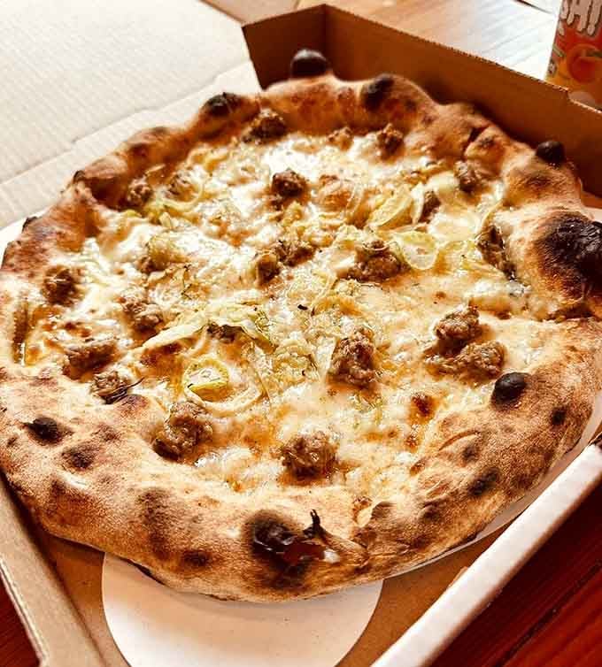 Those golden fennel pieces and perfectly browned sausage on bubbly sourdough crust prove simplicity done right beats complexity done wrong.