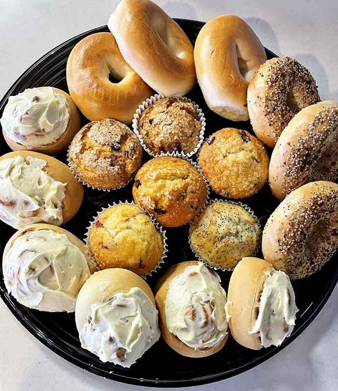Bagels, muffins, and cream cheese unite in perfect harmony on this platter of pure breakfast bliss and joy.