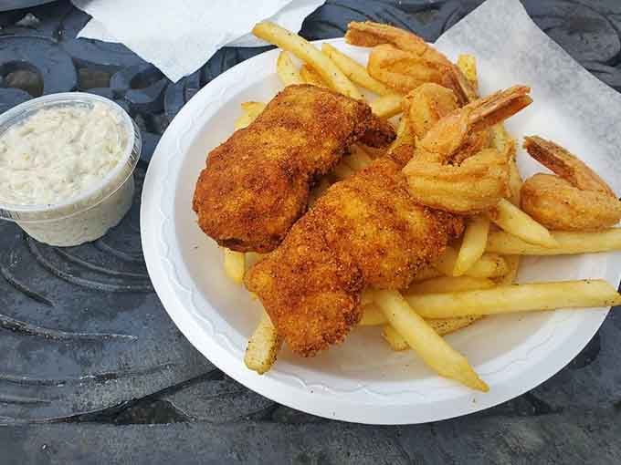 Golden-fried perfection with fries and slaw&mdash;this plate proves that sometimes the simplest presentations deliver the most spectacular flavors.