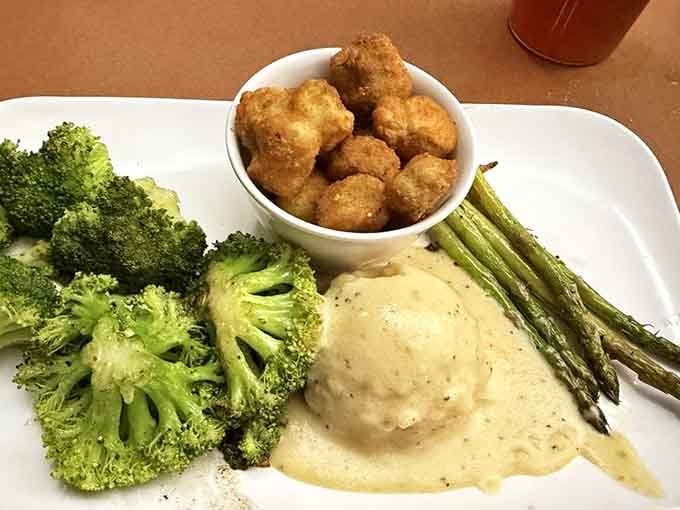 Golden tots, creamy gravy, vibrant broccoli, and asparagus spears make this plate look like a still life painting you'd actually want to eat.
