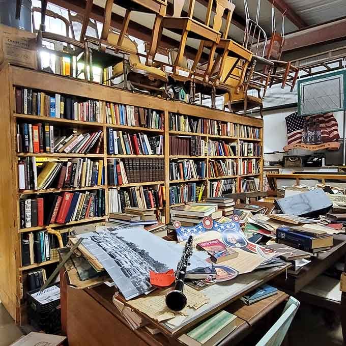 Floor-to-ceiling books and vintage school chairs overhead because why store things normally when you can create art?