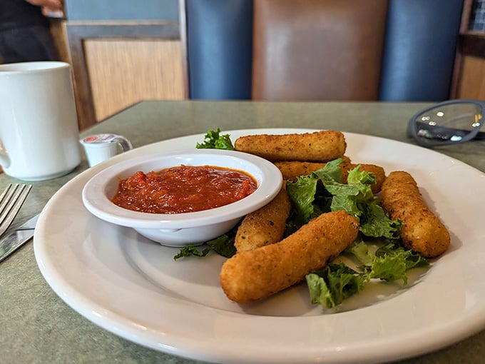 Golden, crispy mozzarella sticks arrive ready for their marinara bath, proving comfort food never goes out of style.