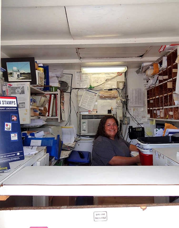 Inside, every inch counts as postal workers masterfully navigate this cozy workspace with impressive efficiency daily.