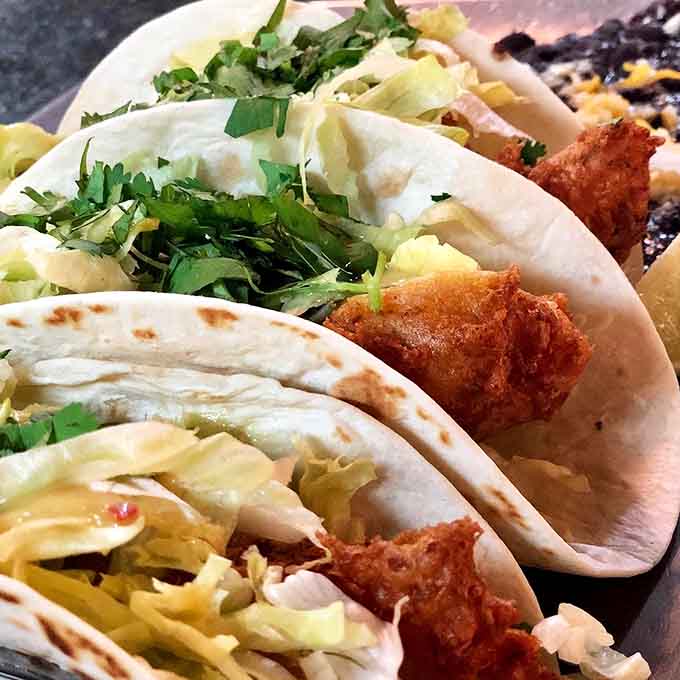 Golden-fried perfection nestled in soft tortillas with fresh cilantro, this is what taco dreams look like in daylight.