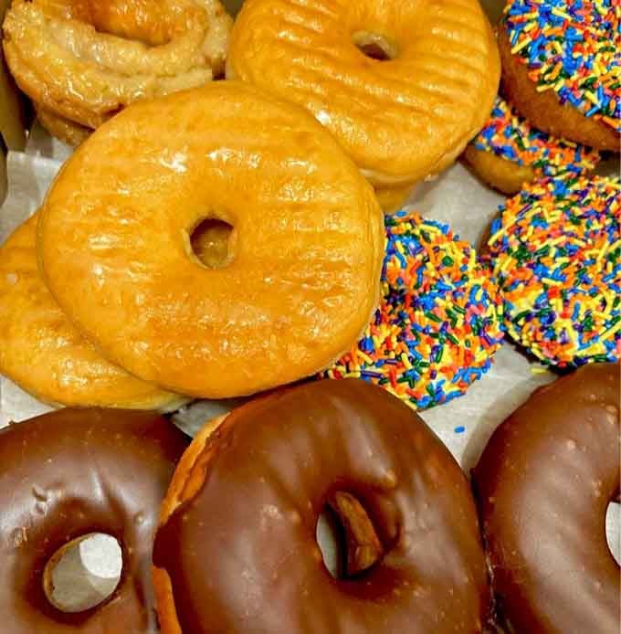 Glazed perfection meets sprinkle-covered chaos in a box that contains more joy than most people's entire week.