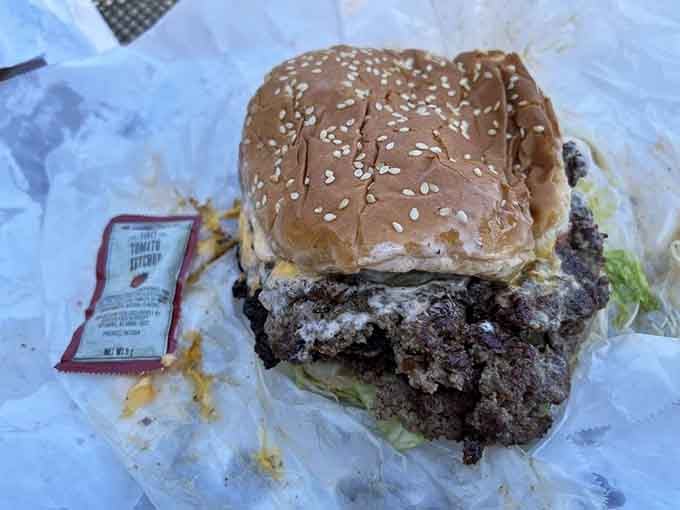 This triple-stacked beauty proves that sometimes more is more, especially when each patty is cooked to juicy perfection.