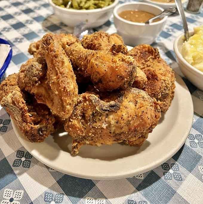 Golden, crispy, and piled high like edible treasure, this is what fried chicken dreams are made of, folks.