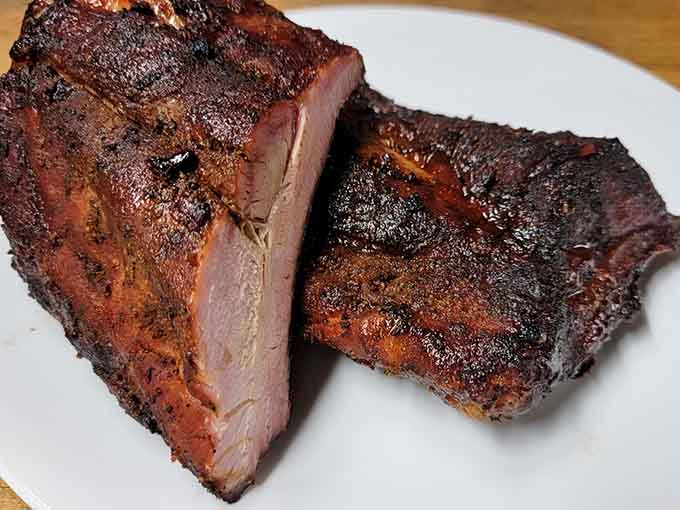 These ribs have that mahogany bark that makes pitmasters weep with joy and vegetarians question their life choices.