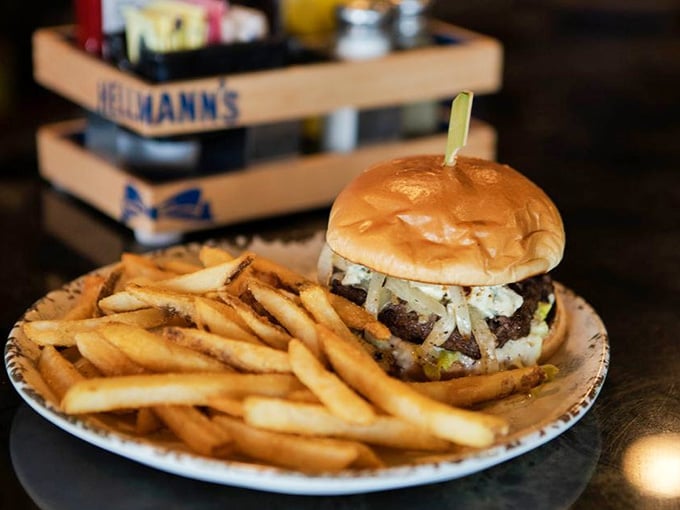 This burger towers like a delicious skyscraper, complete with fries that could end any architectural debate.