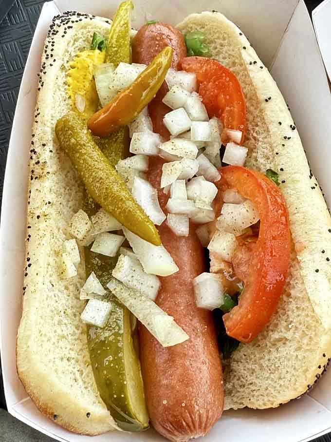 Behold the Woofie Dog in all its Chicago-style glory, proving that perfection comes on a poppy seed bun.