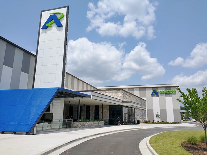 The modern entrance with its sleek architecture hints at the high-tech racing experience waiting inside those doors.
