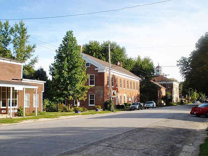 Tree-lined streets and brick buildings create the perfect backdrop for neighbors who still wave from their front porches every evening.