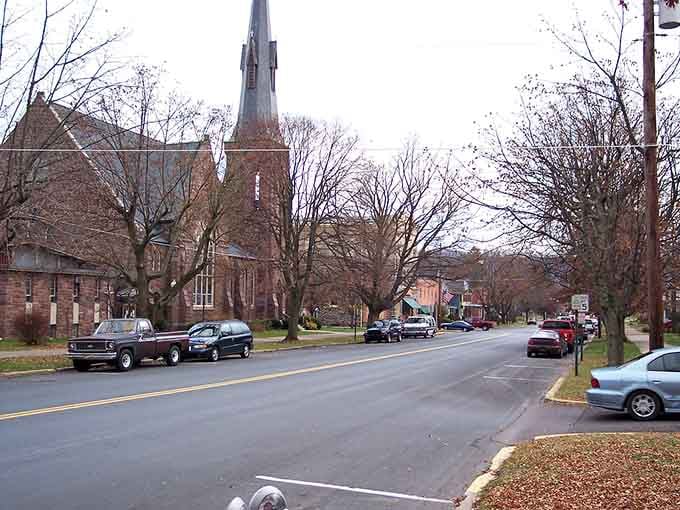 That towering church spire watches over the street like a patient grandfather who's seen generations come and go.
