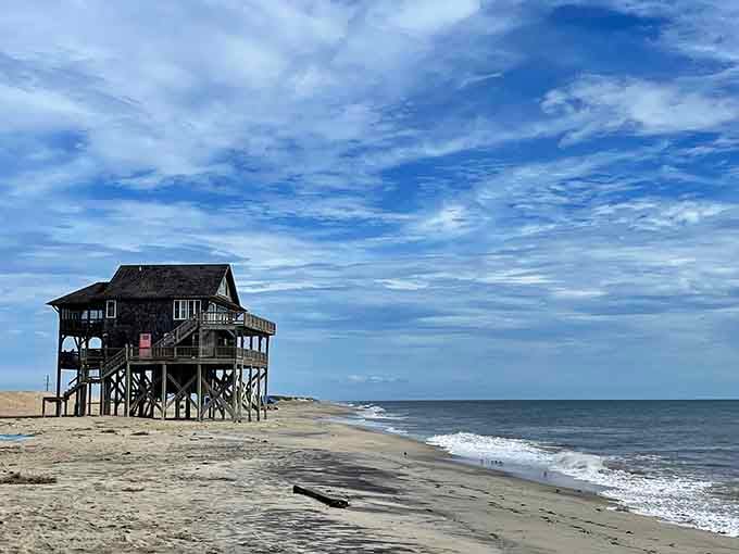 That solitary house on stilts stands defiant against the Atlantic, like a hermit who chose the best office view.