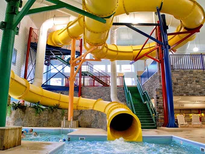 That bright yellow spiral slide dominates the space like a giant piece of sunshine decided to live indoors permanently.
