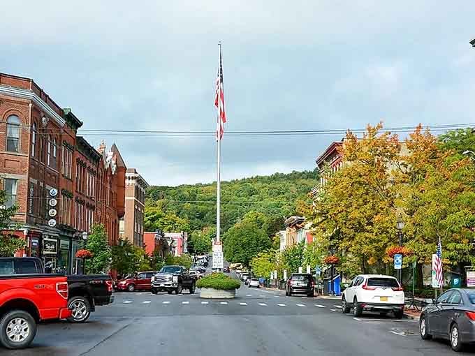 That flagpole stands proud while green hills roll behind it like nature's own amphitheater of beauty.