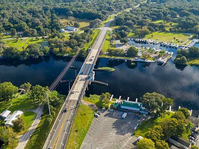 This graceful bridge spans crystal-clear spring waters, connecting lush green landscapes where nature still rules the day.