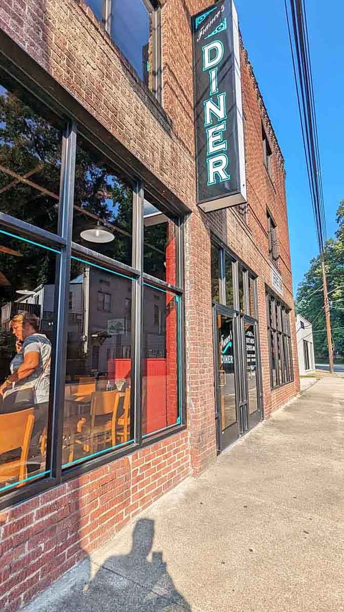 Sunlight catches those big windows, revealing a classic diner interior where locals gather for their daily dose of community.