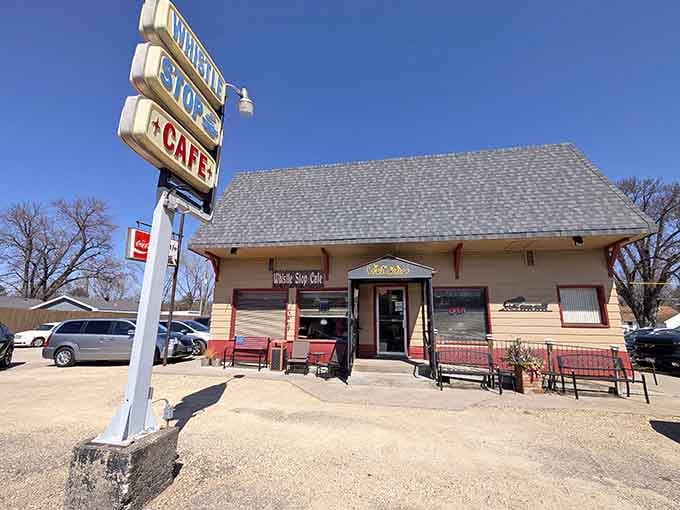 That retro Whistle Stop Cafe sign leaning toward the sky is basically a neon invitation from a simpler, slower, more delicious era.
