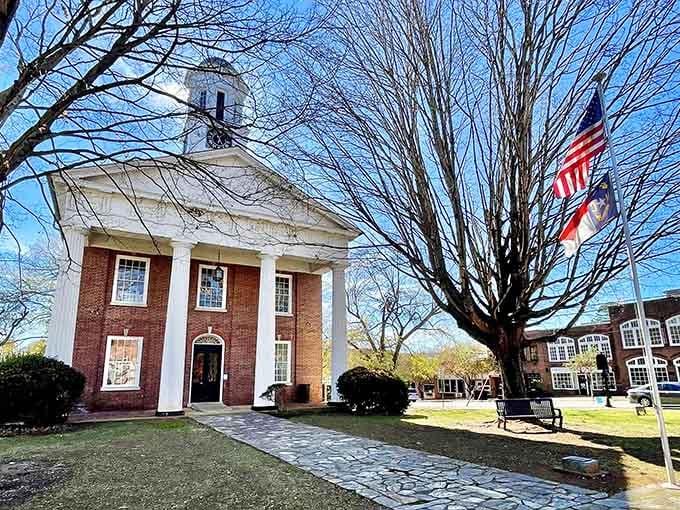 Greek Revival columns stand proud against blue skies, proving that small towns can have serious architectural swagger.