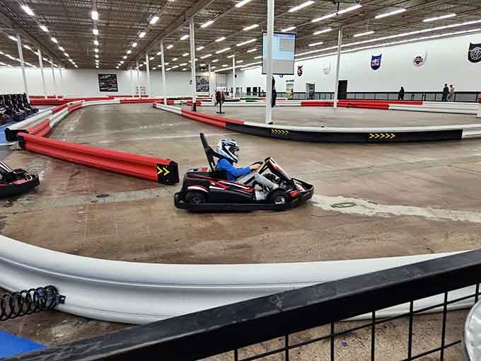 Red barriers guide drivers through sweeping curves where racing dreams come alive without the insurance headaches of actual racing.