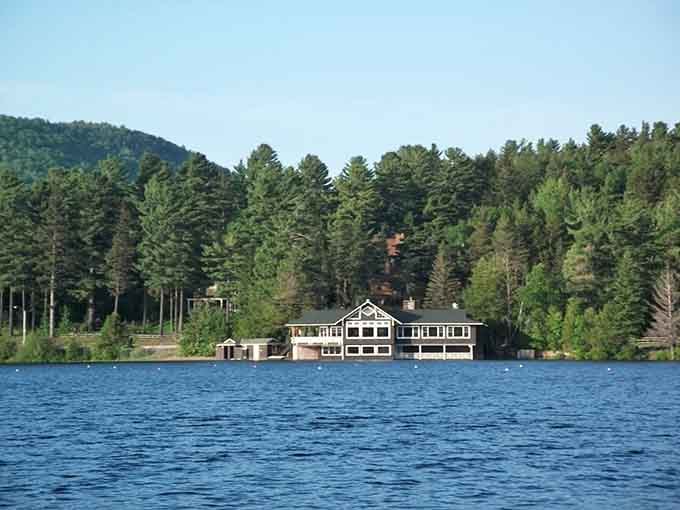 A lakeside boathouse nestled among towering pines offers the kind of peaceful retreat that clears your mind completely.