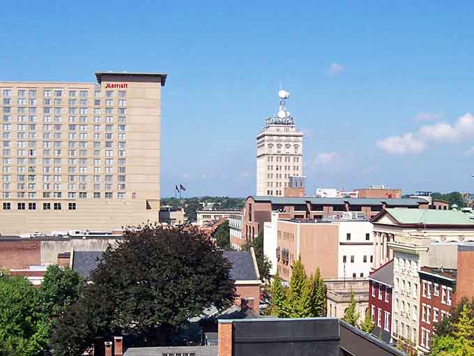 The skyline mixes old and new architecture, with that distinctive tower standing tall like a lighthouse guiding you through downtown streets.