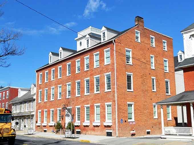 This grand brick building stands four stories of American history, its symmetrical windows watching over the town like a protective guardian.