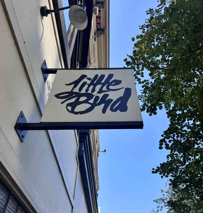 That elegant script sign catches the eye like a handwritten invitation to something special downtown.