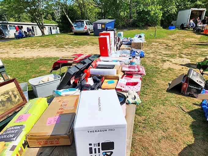 Morning light bathes the field as shoppers browse tables filled with various collectible finds.