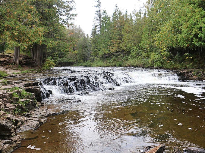 Wide cascading falls tumble over layered rock shelves, creating nature's own water park without the admission lines or chlorine.