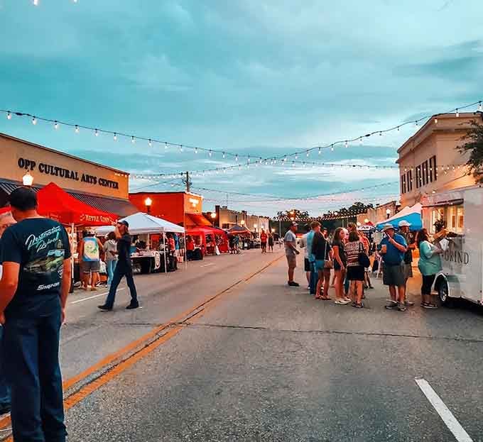 String lights glow above evening crowds at this street festival where food trucks and community spirit create magic.