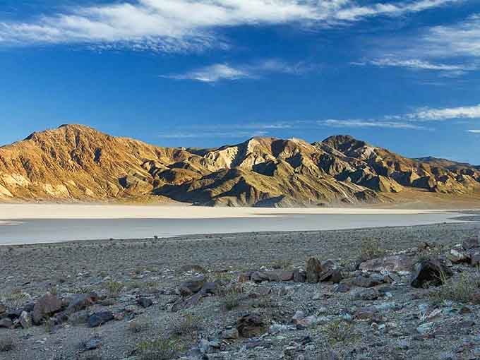 The playa stretches endlessly flat, where mysterious rocks leave trails across the cracked earth like nature's own Etch A Sketch.