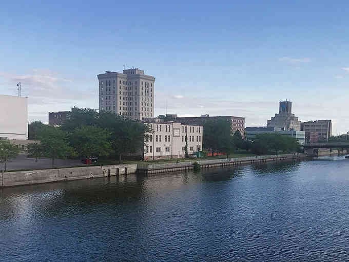 The riverside skyline mixes old and new, with tall buildings standing guard over the water like sentinels.