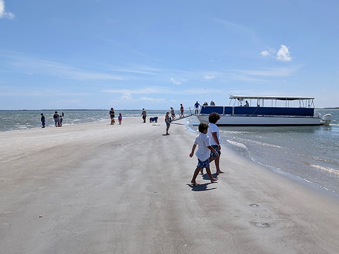 A boat waits patiently at this pristine sandbar island where the water stays shallow and crystal clear.