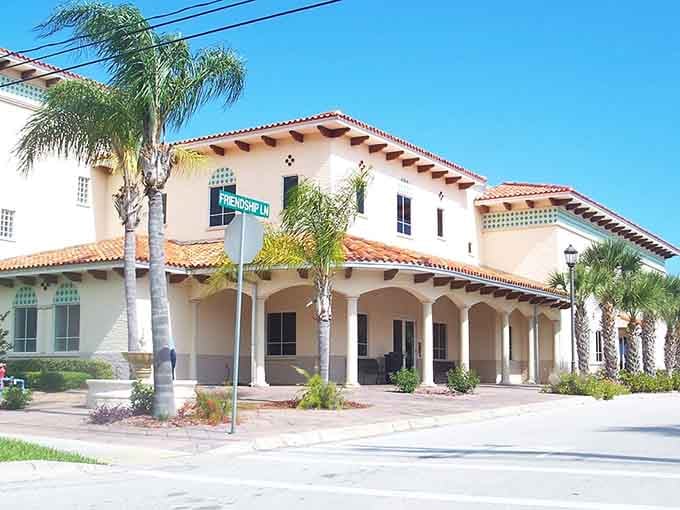 Spanish-style architecture meets swaying palms in a scene that whispers "retirement paradise" with every terracotta tile.