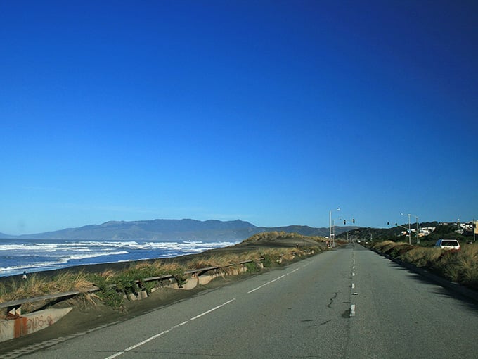 Coastal bluffs rise like ancient sentinels guarding the shoreline, making every mile feel wonderfully cinematic.