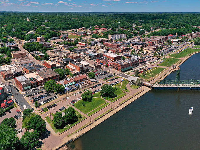 The river curves around downtown like a liquid highway, connecting neighborhoods and history in one sweeping aerial view.