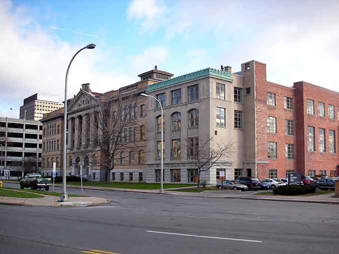 Fire escapes climb brick facades in neighborhoods where real people live without spending their entire paycheck on rent.