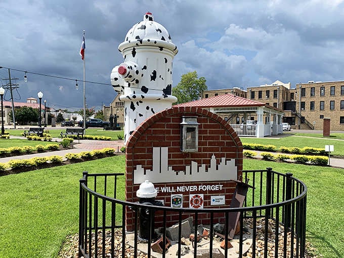 That spotted dalmatian tower stands guard like a faithful firehouse companion watching over the memorial below.