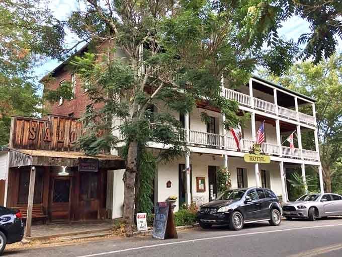 The historic hotel's white balconies and flags create a scene straight from a Gold Rush-era Western film.