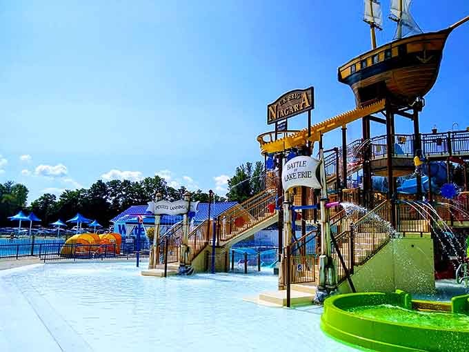 That pirate ship stands guard over splashing families like a wooden sentinel of summer joy.