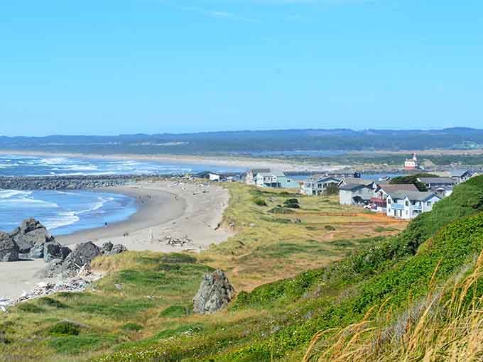 Bandon's dramatic coastline stretches for miles, featuring rocky outcrops, sandy beaches, and the historic Coquille River Lighthouse in the distance.