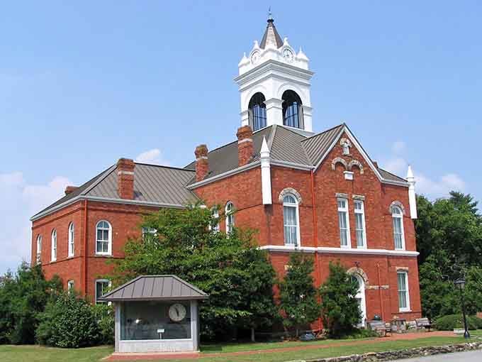The ornate courthouse tower reaches skyward with Victorian confidence, declaring this town means serious business about its heritage.