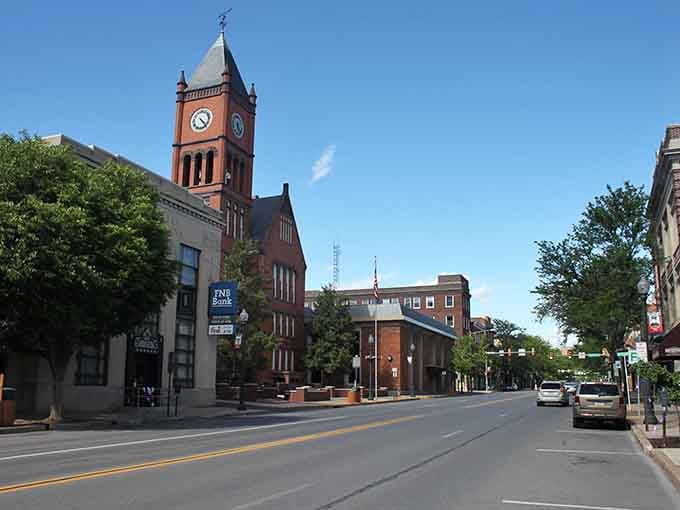 The clock tower stands proud against blue skies, keeping time for a community that still values its downtown heartbeat.