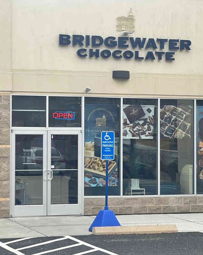 Those window graphics showcase tempting chocolate creations—like a preview of coming attractions, but way more delicious than any movie.