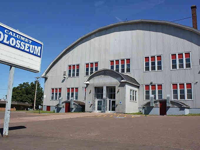 The Calumet Colosseum's distinctive curved roof has sheltered community gatherings for over a century of Michigan winters.