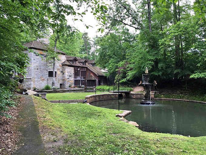 Stone walls meet serene water features in a forest setting that feels both ancient and utterly peaceful.